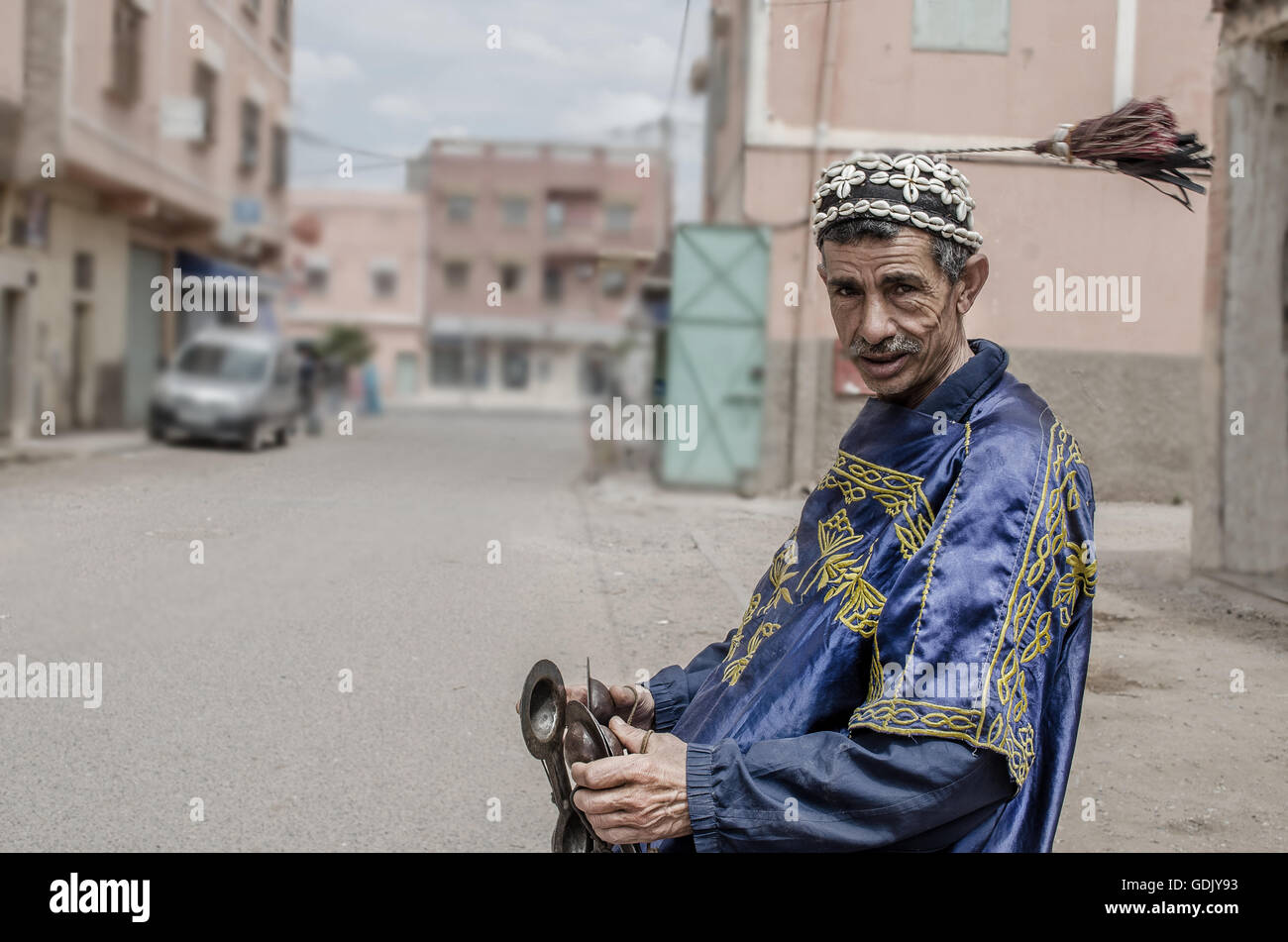 Street Gnawa Musician wearing gnawa outfit and holding Krakebs (gnawa ...