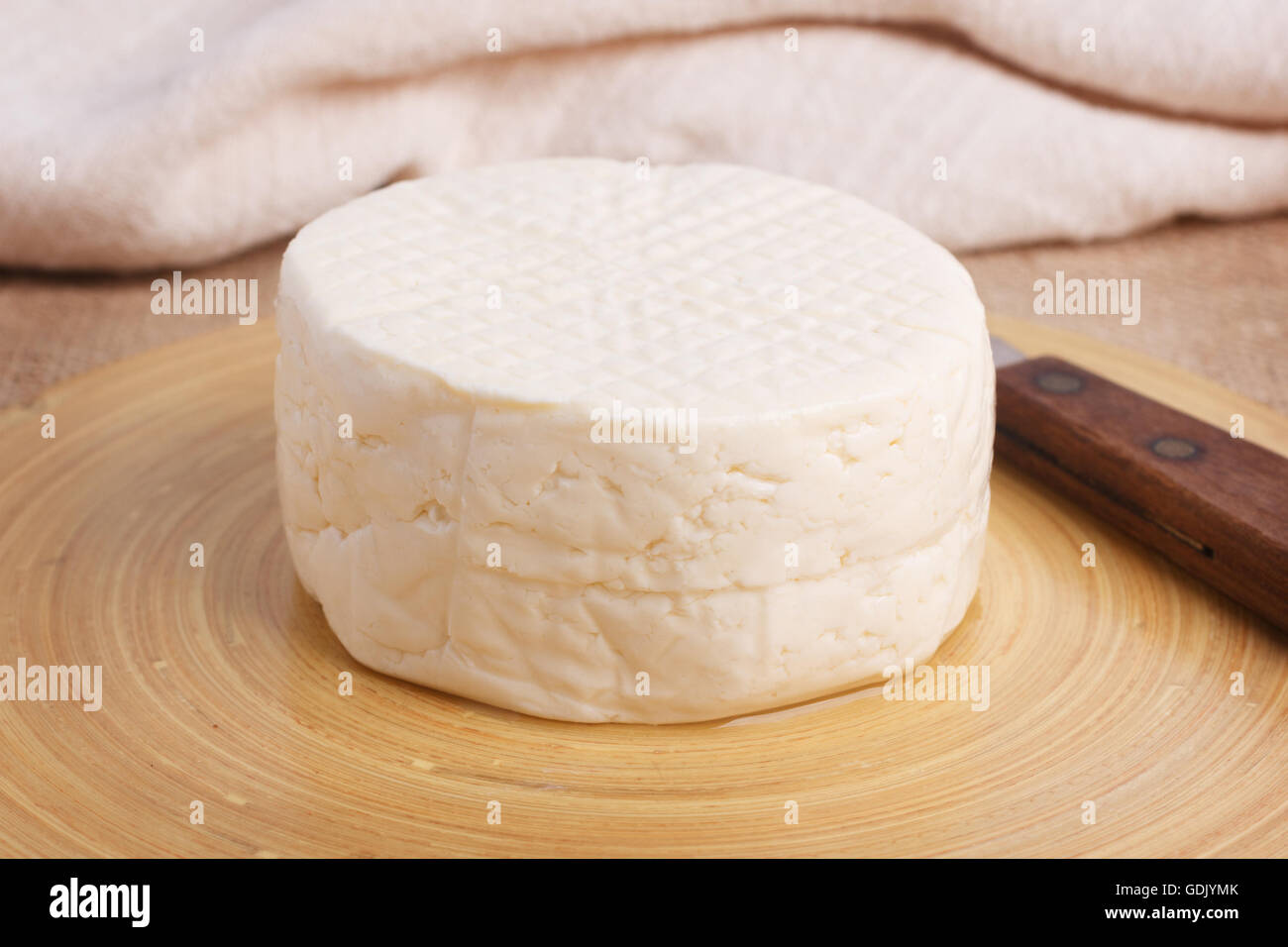 Wheel of brazilian traditional cheese Minas on wooden board. Selective ...