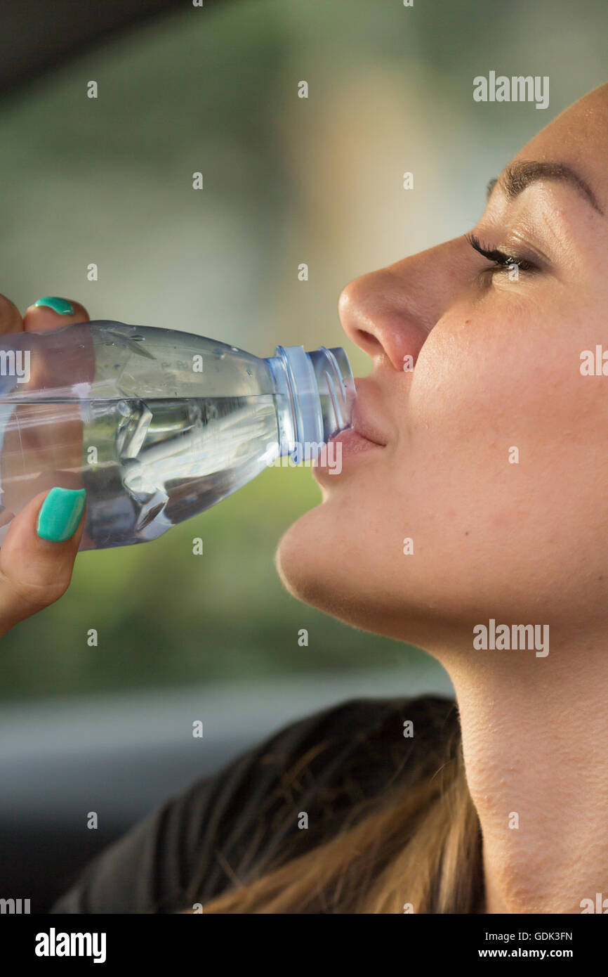 Girl drinks fizzy water from clear plastic bottles Stock Photo - Alamy