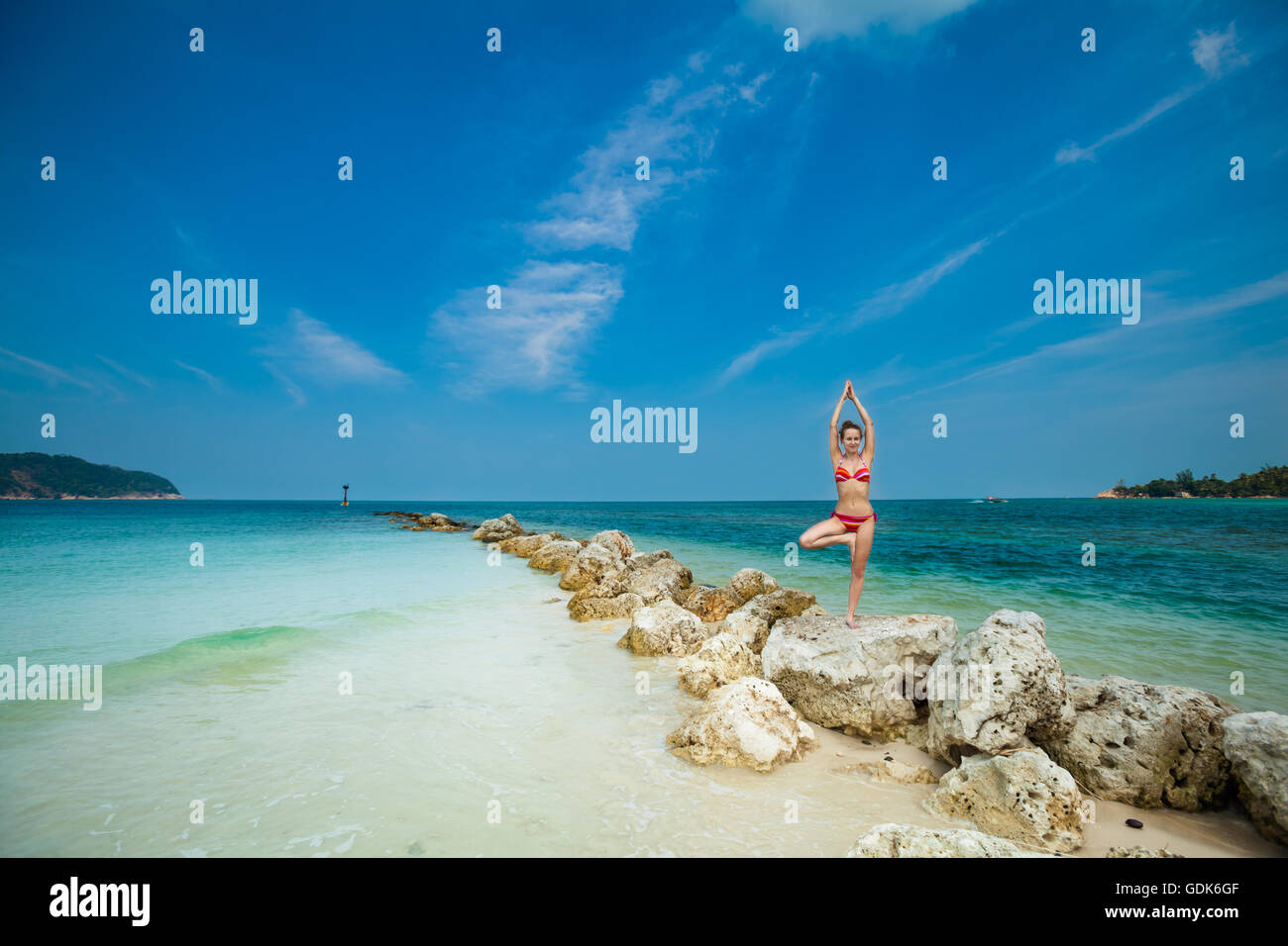 Hot summer yoga session on a beach - tropical Koh Phangan island ...