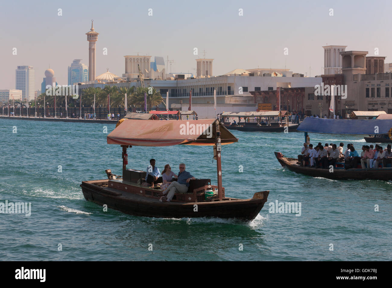 Abra ferry boat on Dubai Creek with modern skyline in the distance in ...