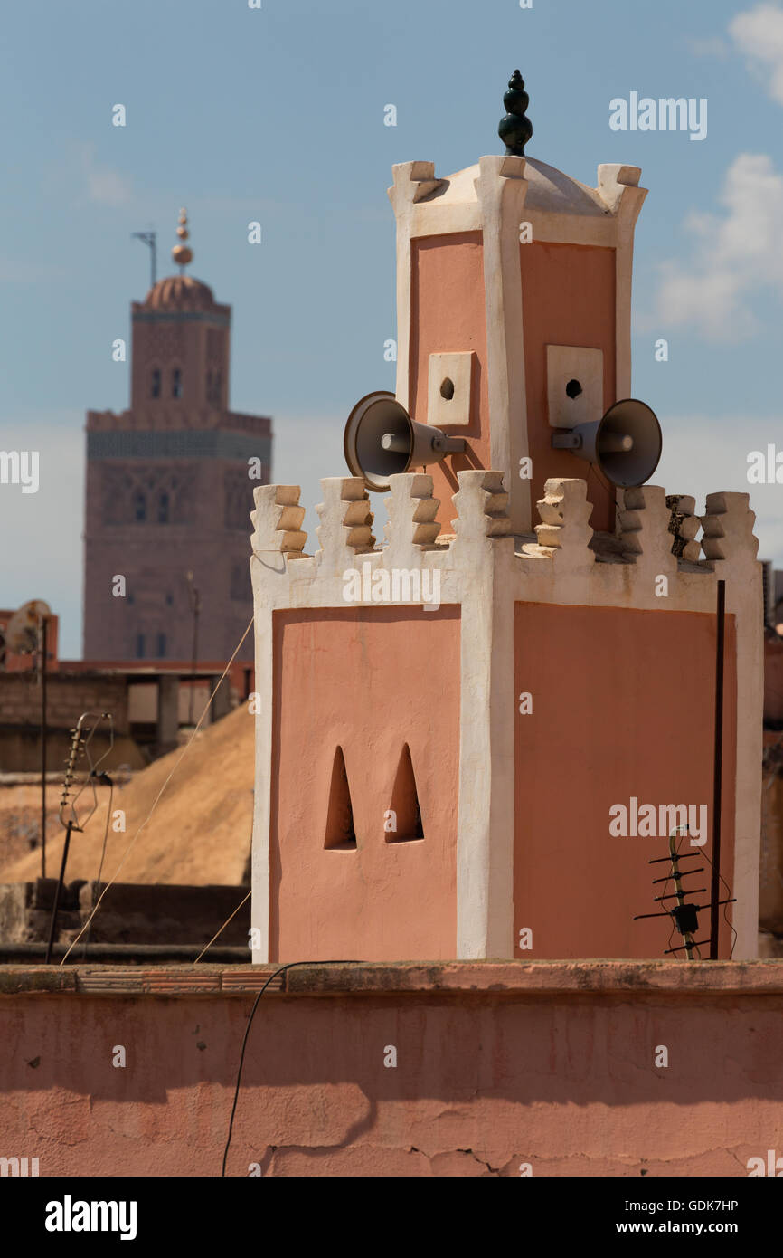 Minaret of small mosque with Koutubia Mosque in the background, Morocco ...