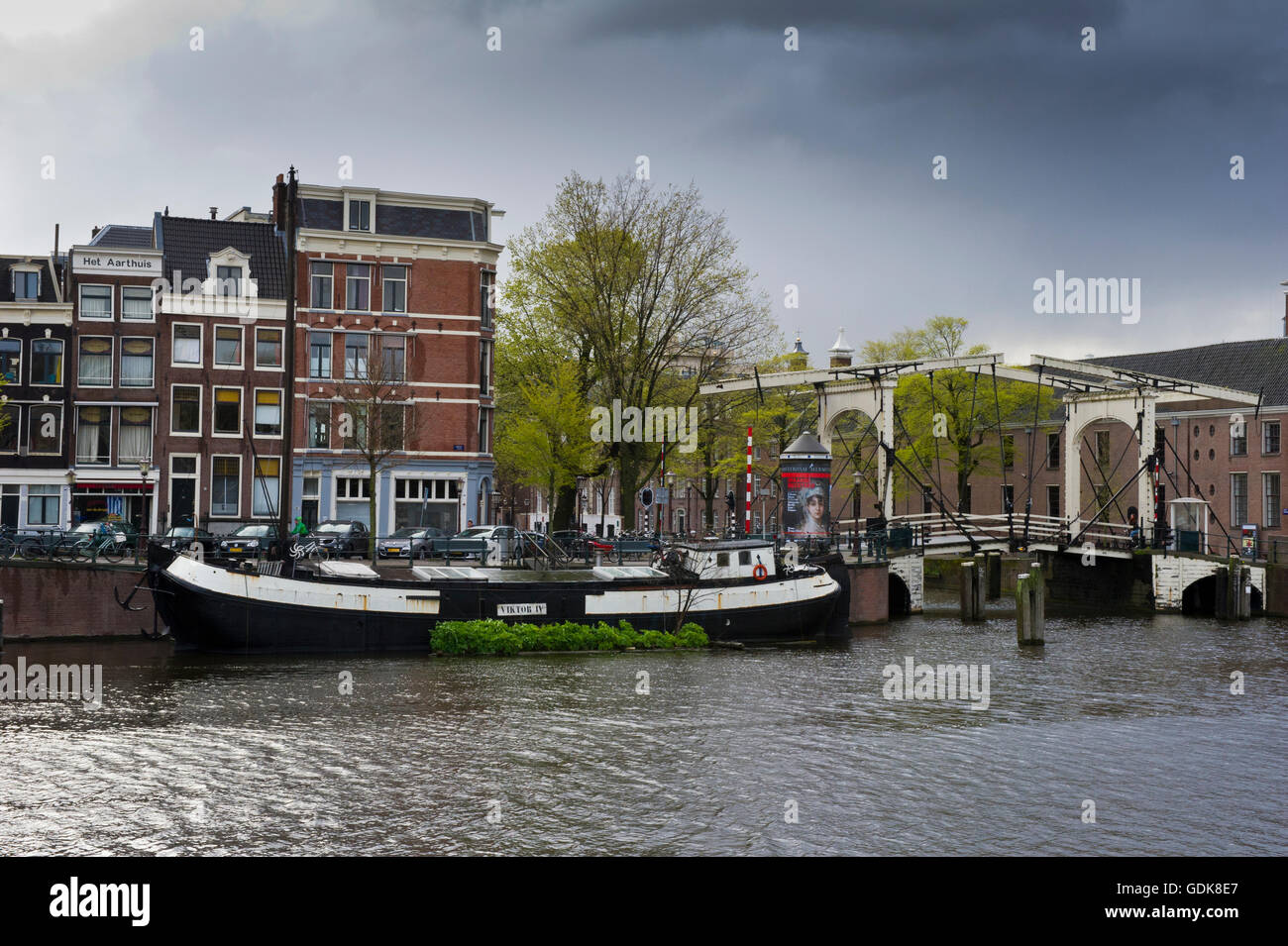 A traditional wooden bridge crossing the canal in Amsterdam, Holland ...