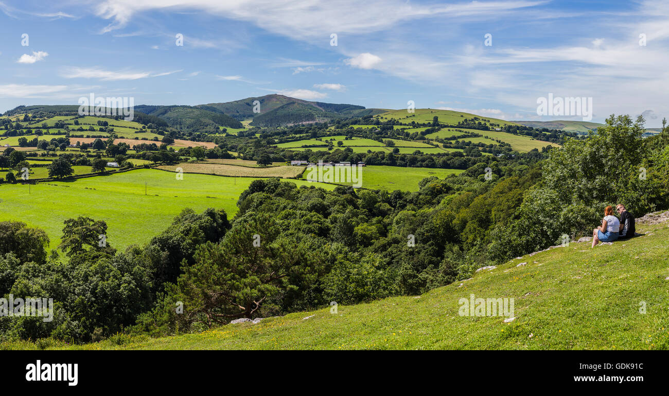 A middle-aged couple sit on the edge of the peak at Loggerheads Country ...