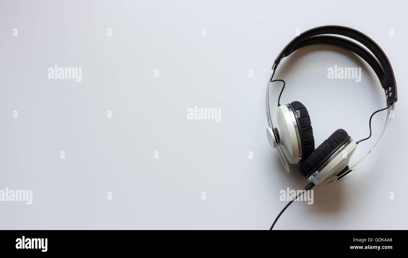 Single headphones on a table Stock Photo - Alamy