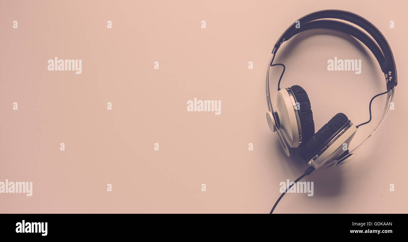 Single headphones on a table Stock Photo - Alamy