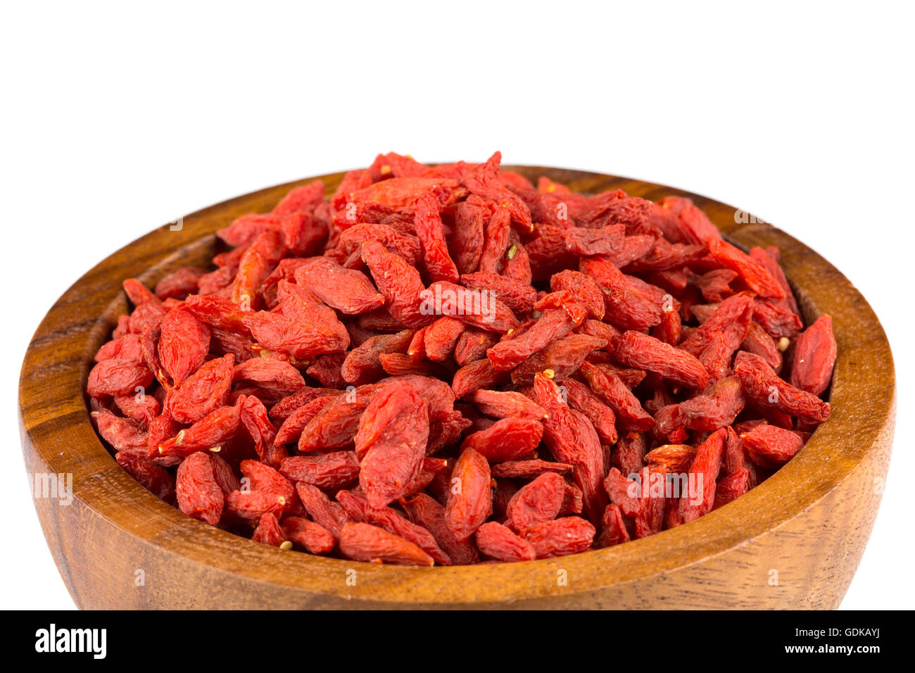 Chinese goji berries in wooden bowl close up on white background Stock ...