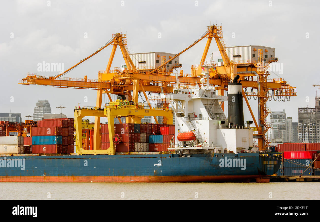 Industrial Container Cargo freight ship with working crane bridge in ...