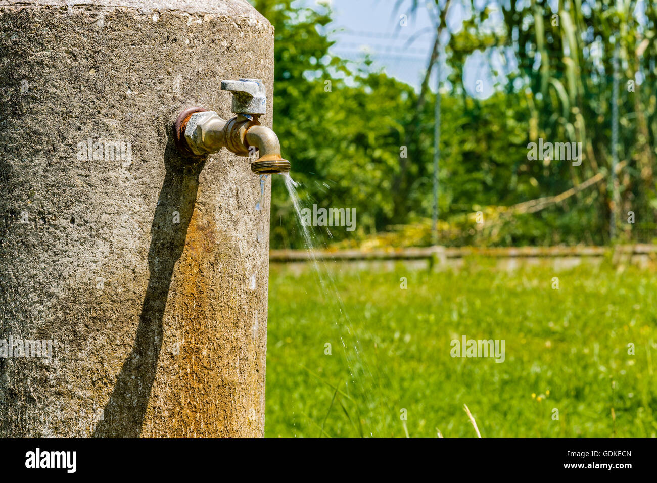old rusty faucet leaks, a flow of water is coming down Stock Photo - Alamy