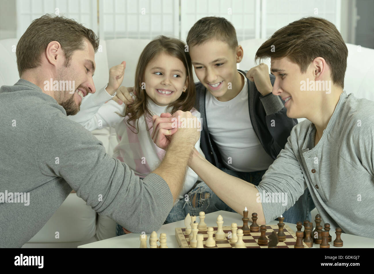 Family playing chess at home Stock Photo - Alamy