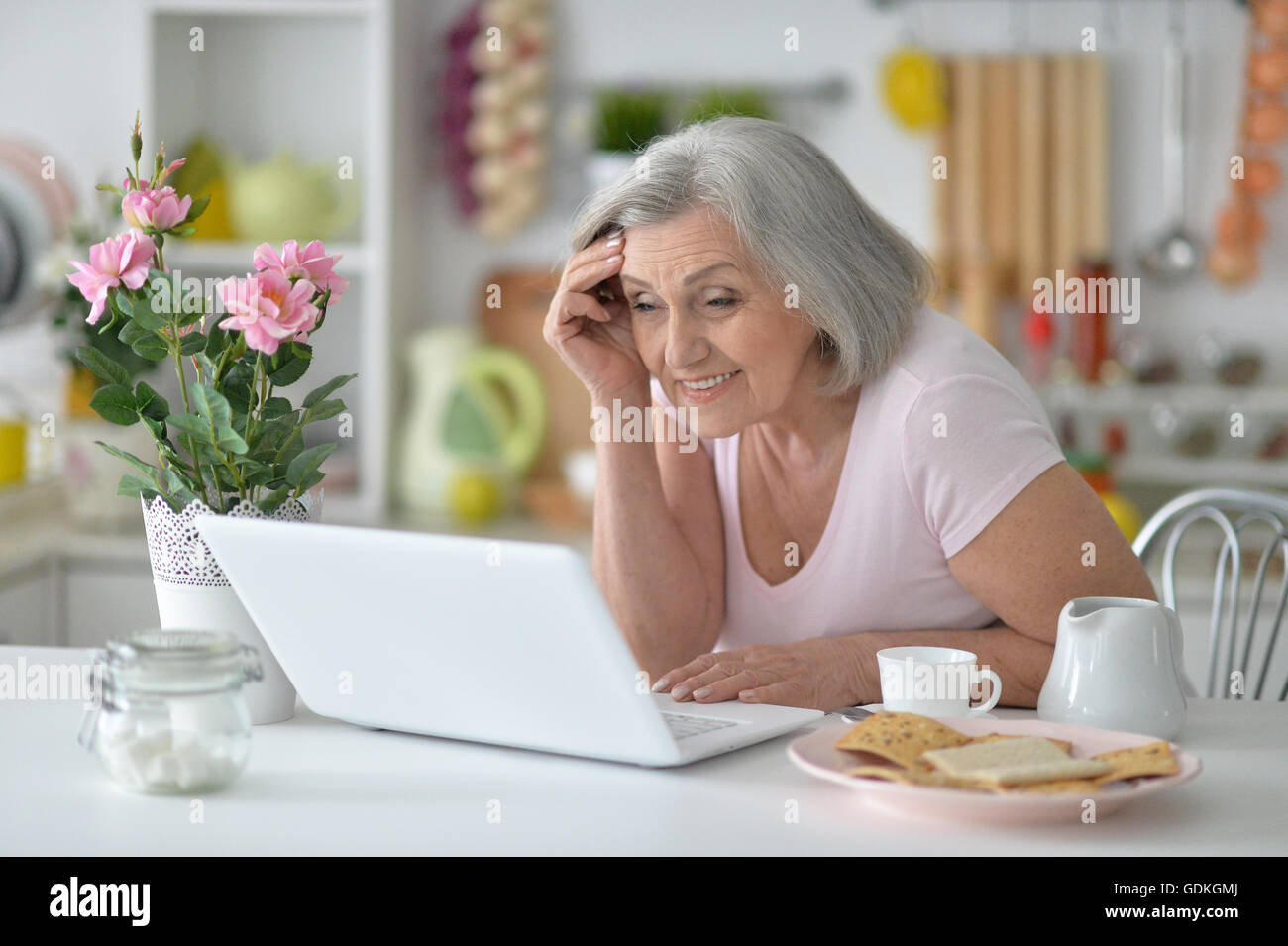 Senior woman with laptop Stock Photo - Alamy