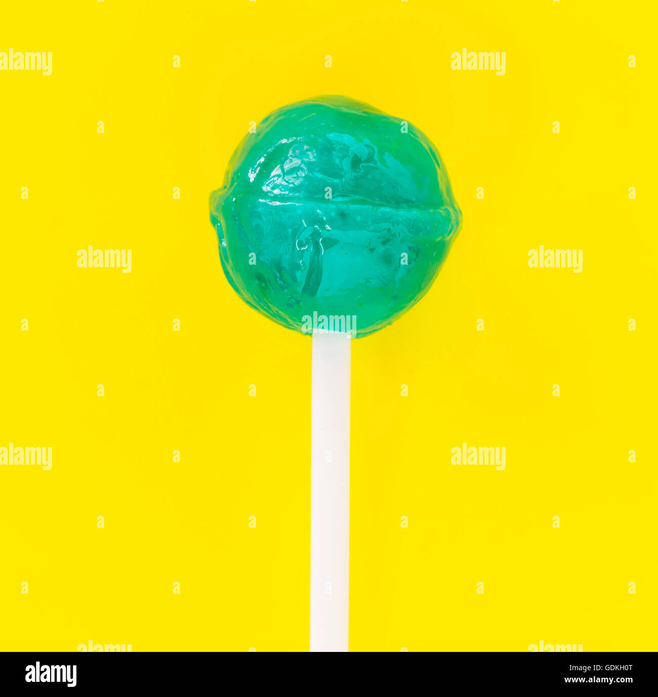 Colorful small lollipops on Yellow background Stock Photo - Alamy