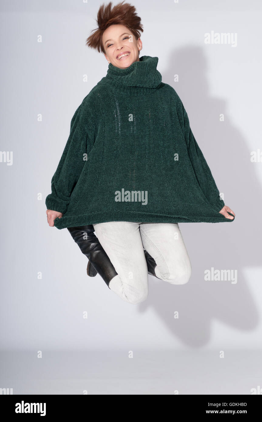 Female model jumping at studio Stock Photo - Alamy