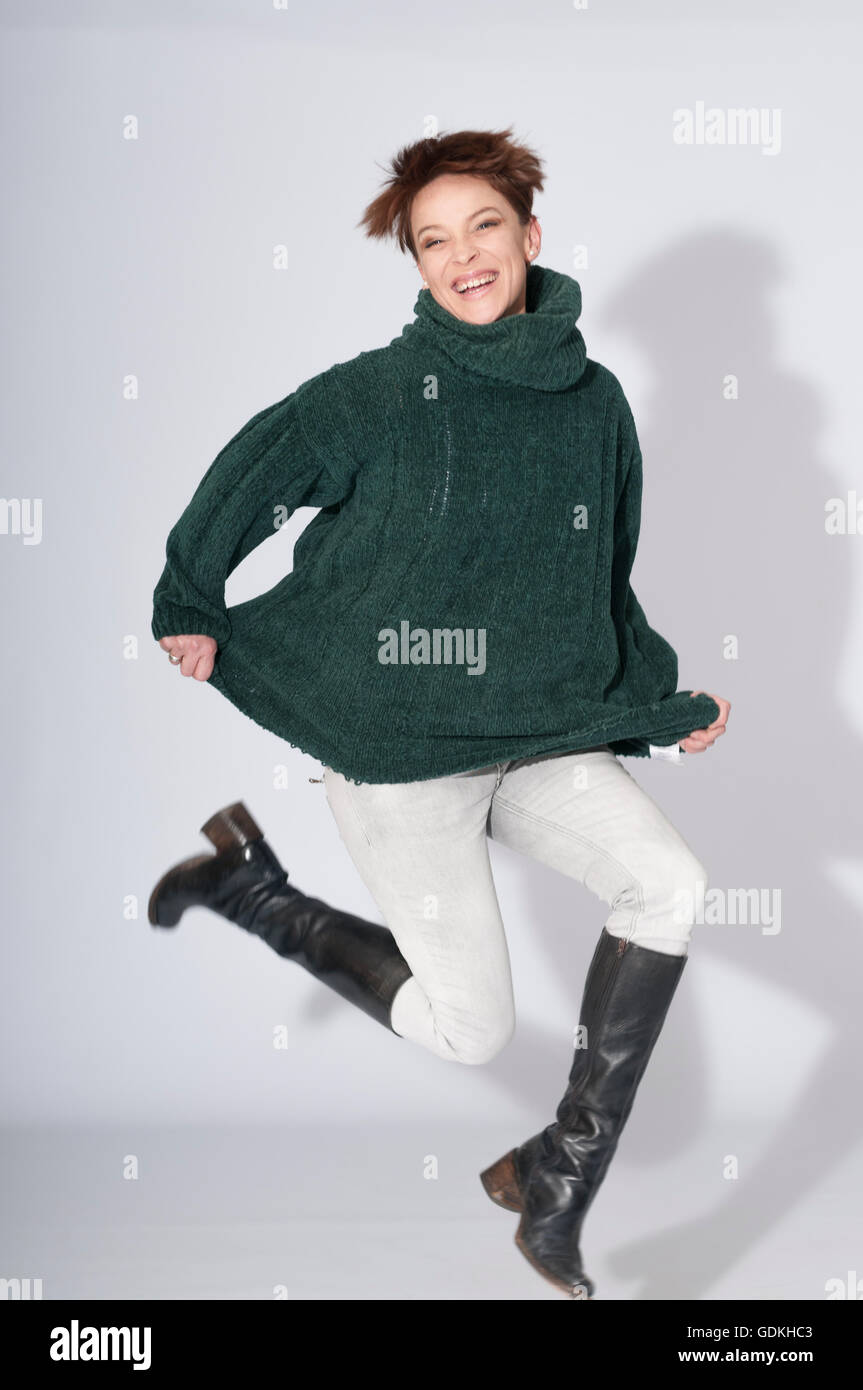 Female model jumping at studio Stock Photo - Alamy