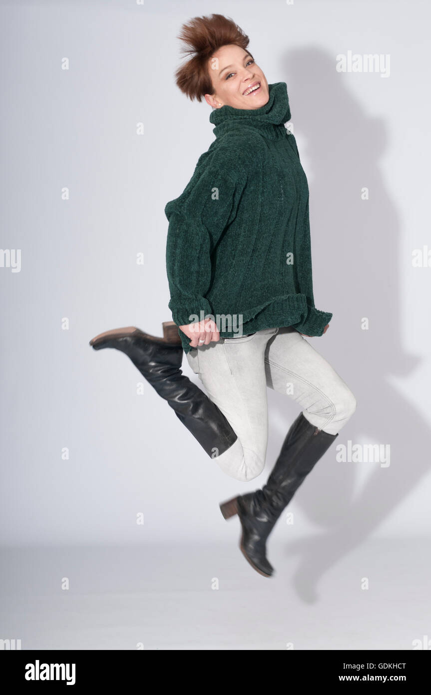 Female model jumping at studio Stock Photo - Alamy