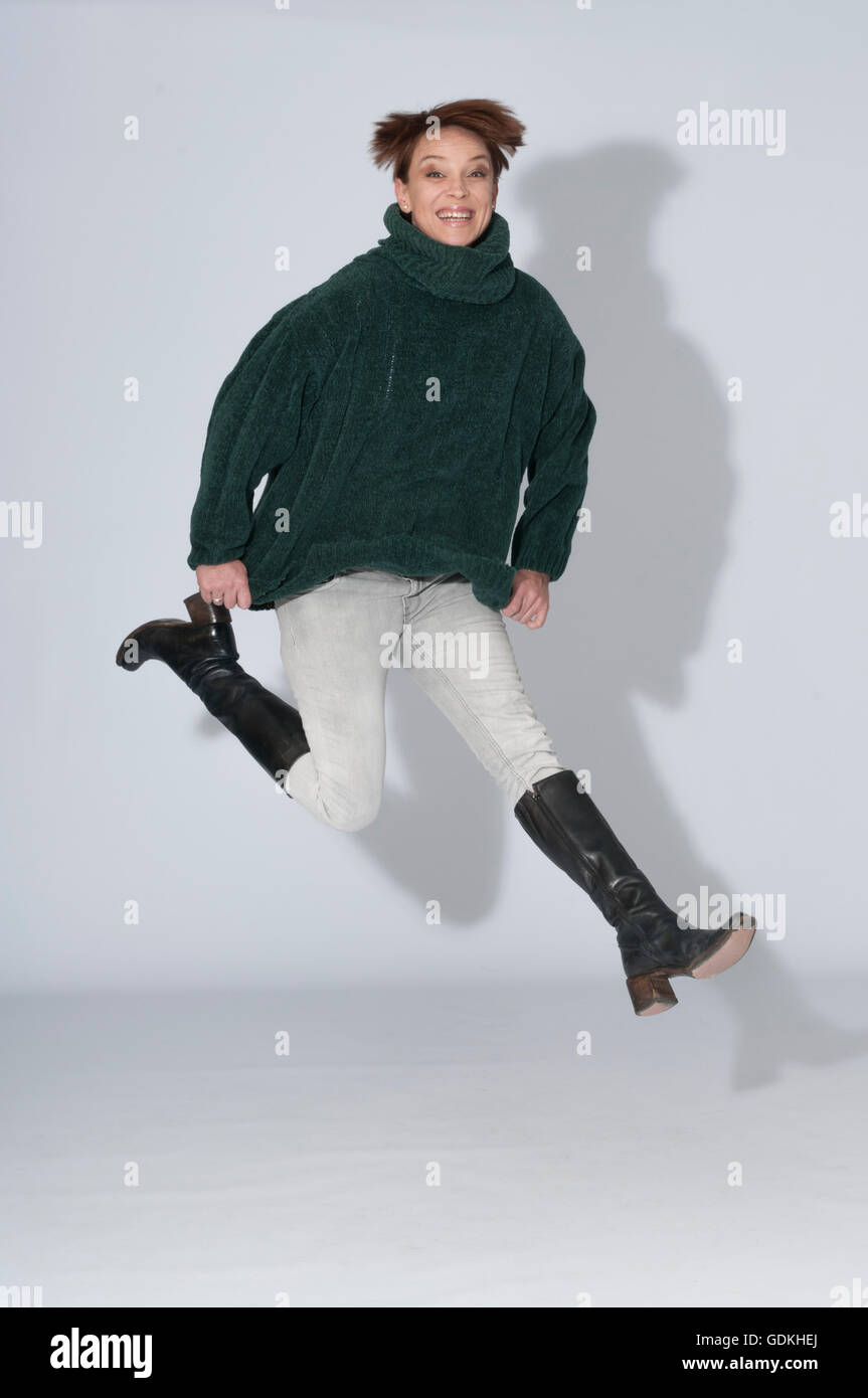 Female model jumping at studio Stock Photo - Alamy