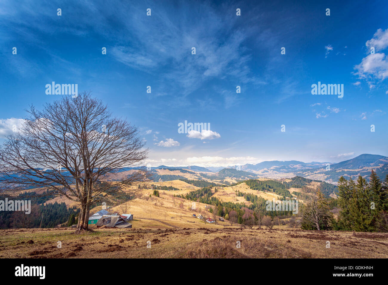 landscape, village in the mountains and spring snow-capped mountain ...