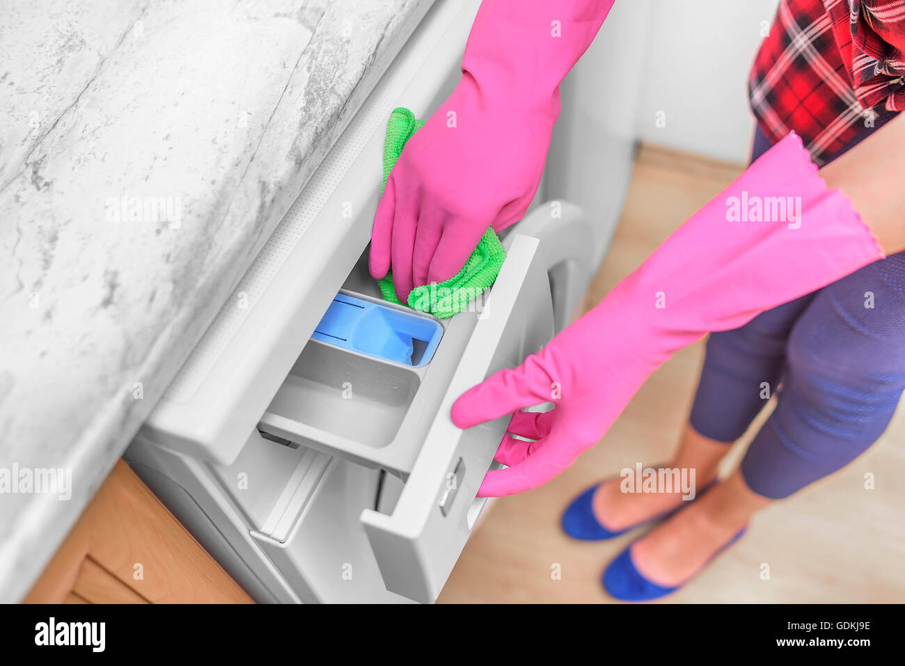 Female hands in gloves washing washing machine. Close-up Stock Photo ...