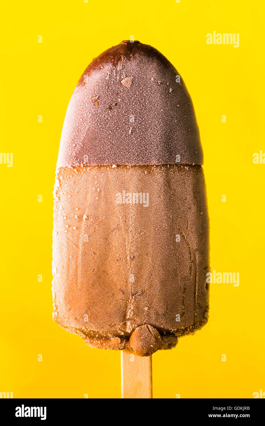 Stick ice cream flavored chocolate on a yellow background Stock Photo ...