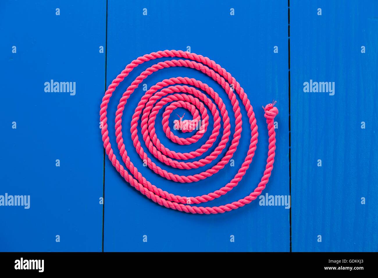Pink rope circle on blue background Stock Photo - Alamy