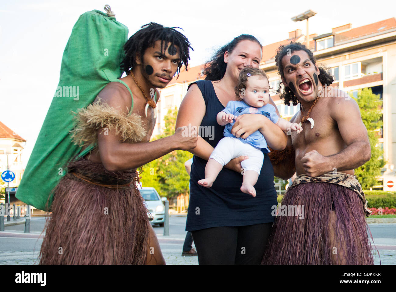 Mother with a young baby posing for a group photo with two members of ...