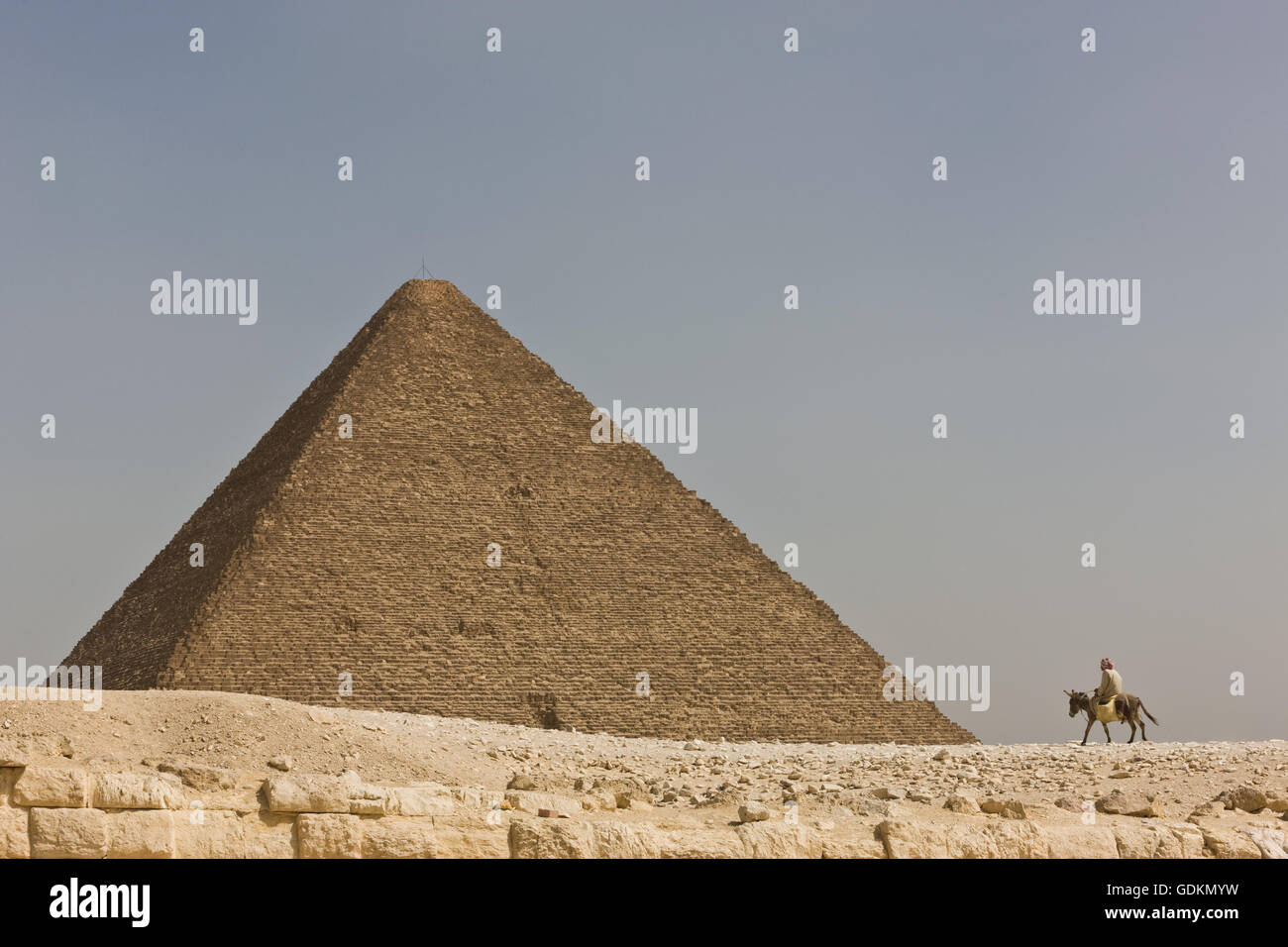 Man on a donkey passing the Great Pyramid, Giza, Cairo, Egypt Stock ...