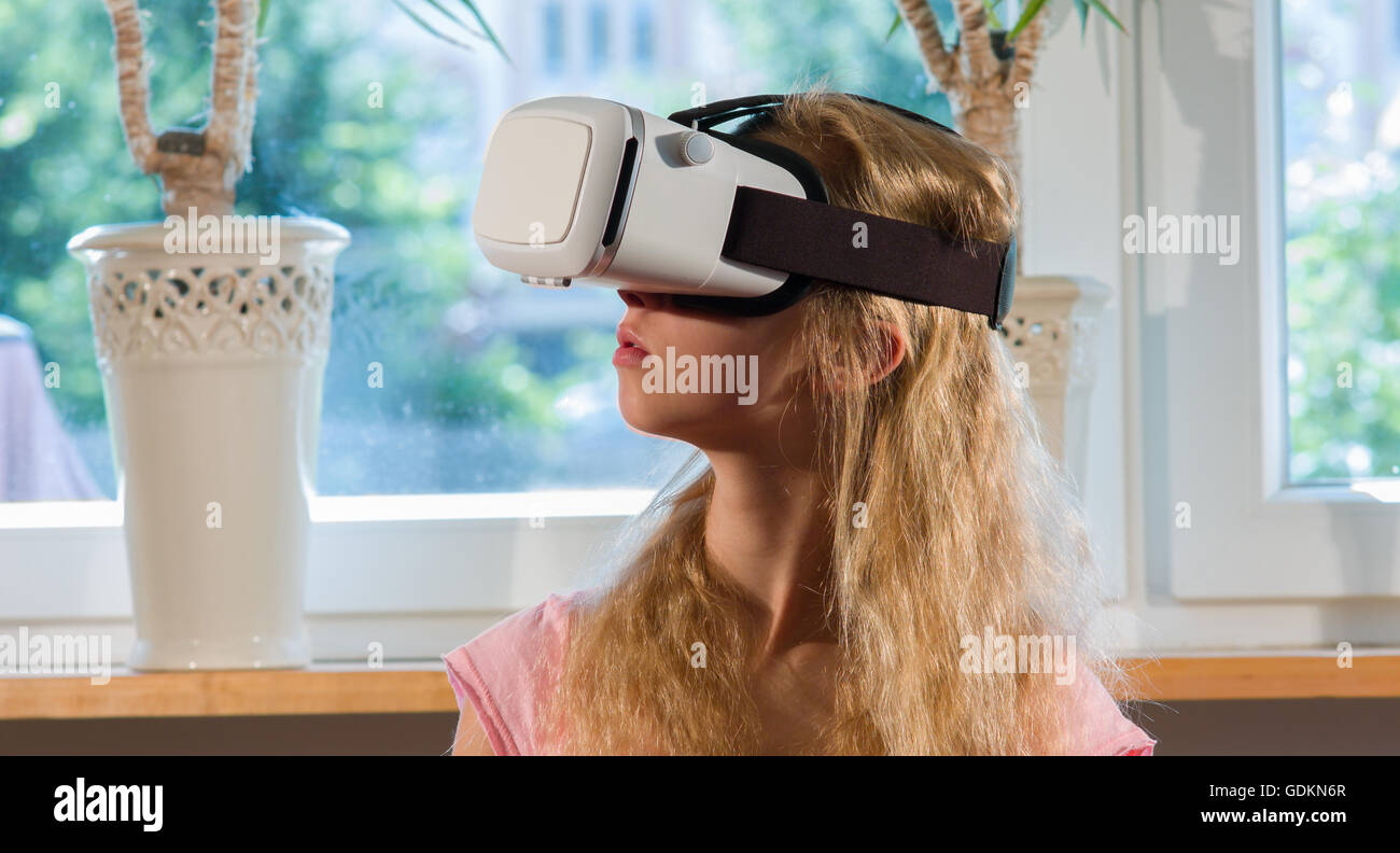 Young girl watching 360 degrees video Stock Photo - Alamy
