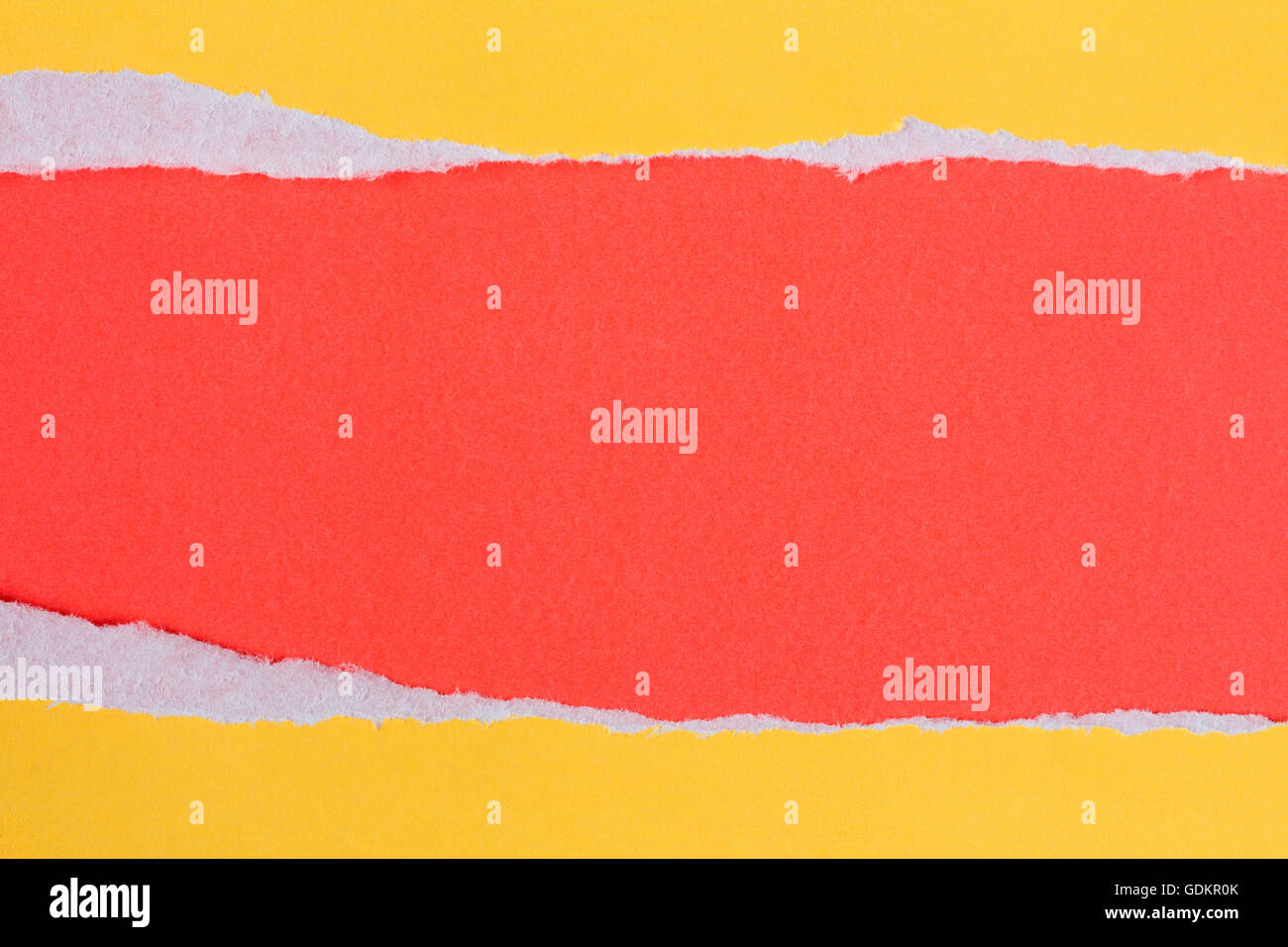 Torn yellow paper with a red background for your text Stock Photo - Alamy