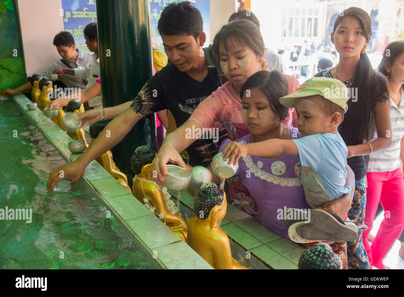 people at the Mahamuni temple in the City of Mandalay in Myanmar in ...
