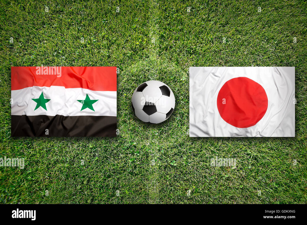 Iraq vs. Japan flags on green soccer field Stock Photo - Alamy