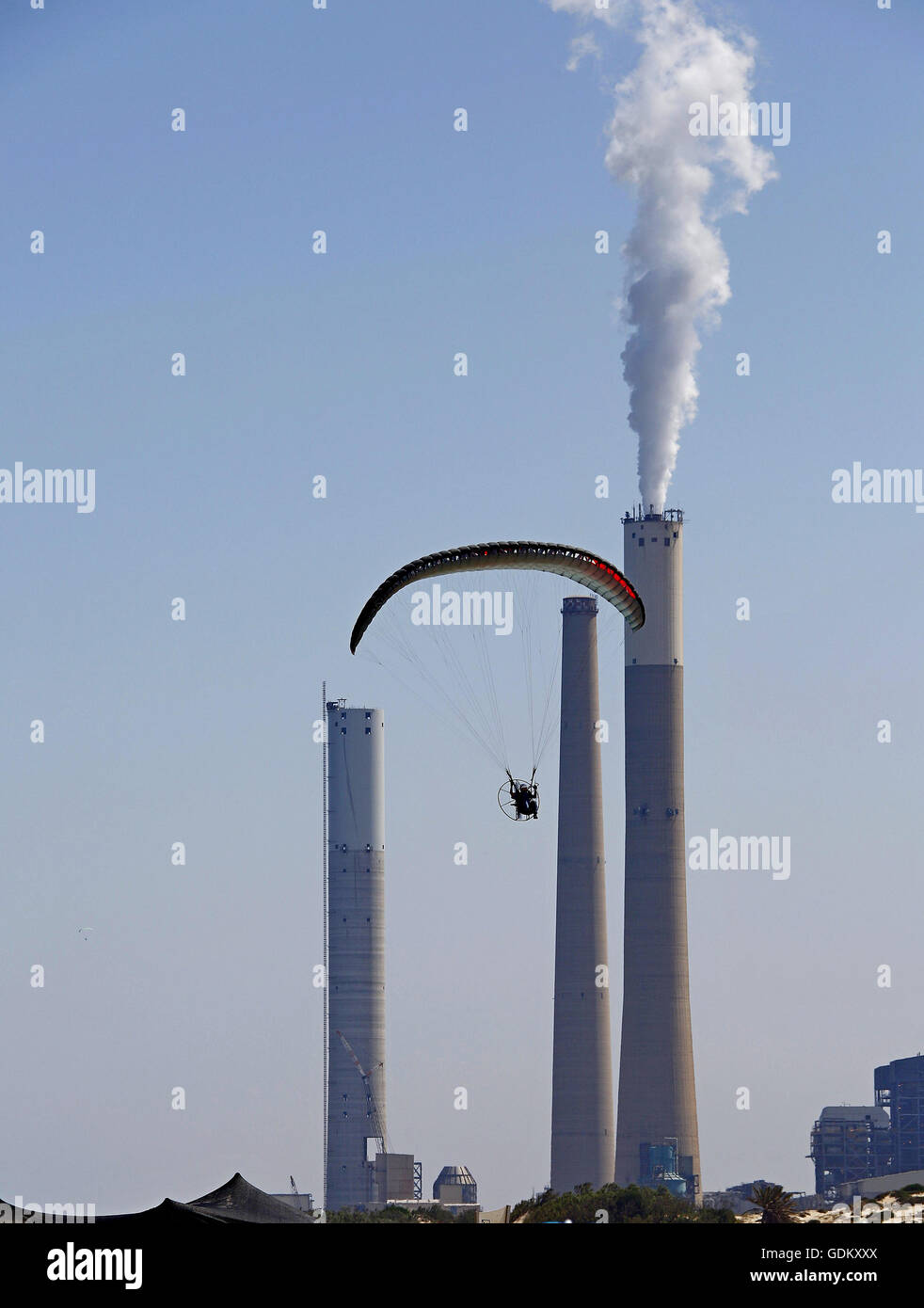 parachutist flying on a background of factory pipes and blue sky Stock ...