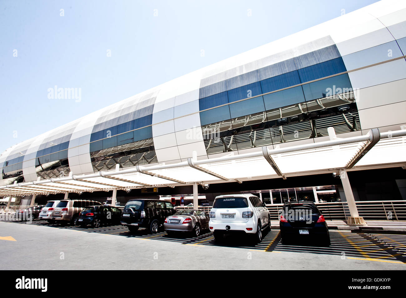 Men filling out cards at the racecourse, Dubai, UAE Stock Photo - Alamy