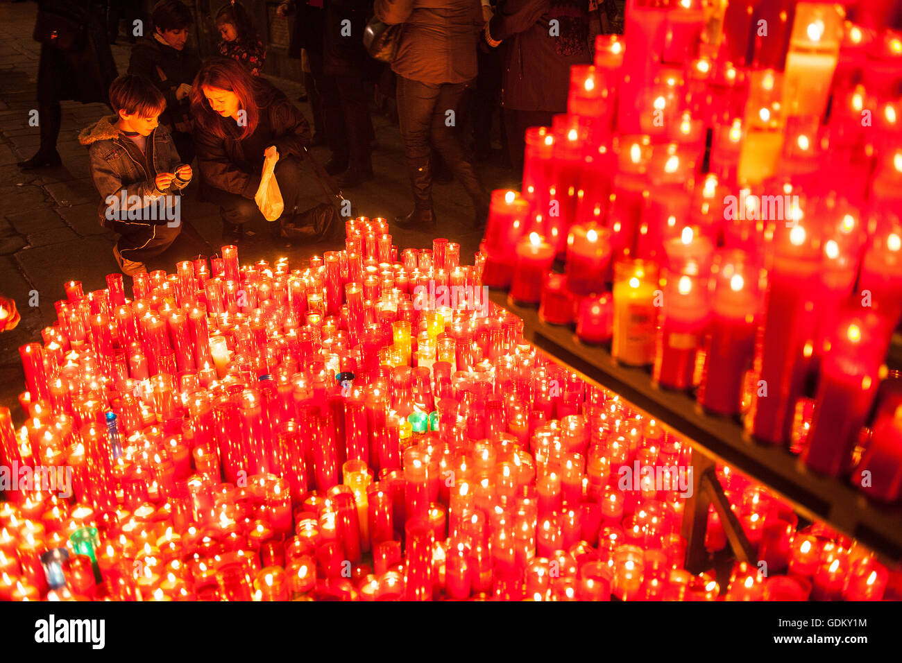 Barcelona's cathedral, Gothi. People praying and Lighted candles ...