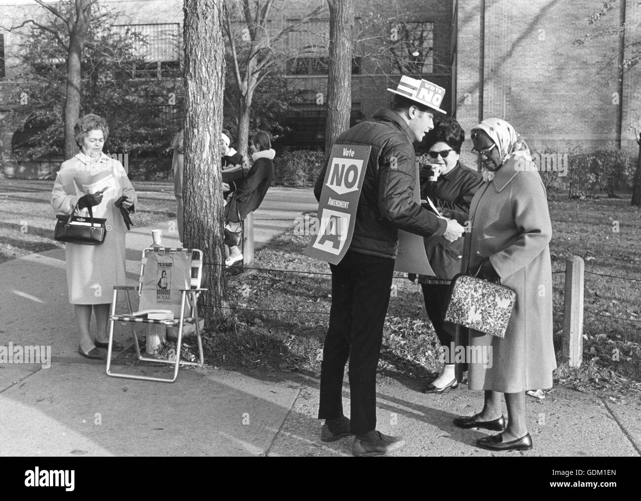 Campaign workers in Detroit, Michigan greet voters on their way to the ...