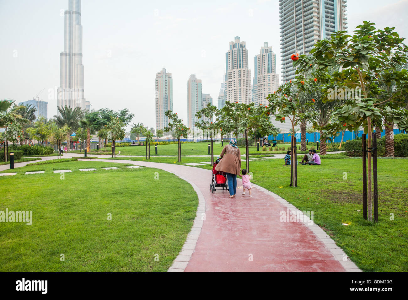 A woman and child take a stroll through the Business Bay Park, Dubai ...