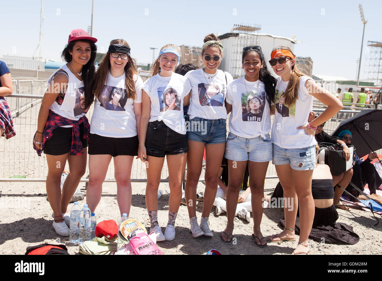 One Direction fans pose for the camera before the concert, The Sevens ...
