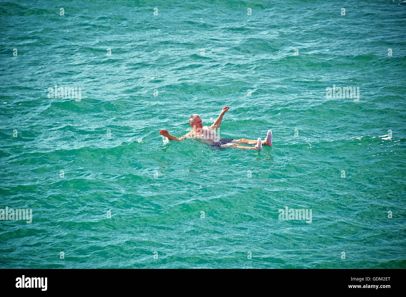 Swimmer floating in the Dead Sea, Jordan Stock Photo - Alamy