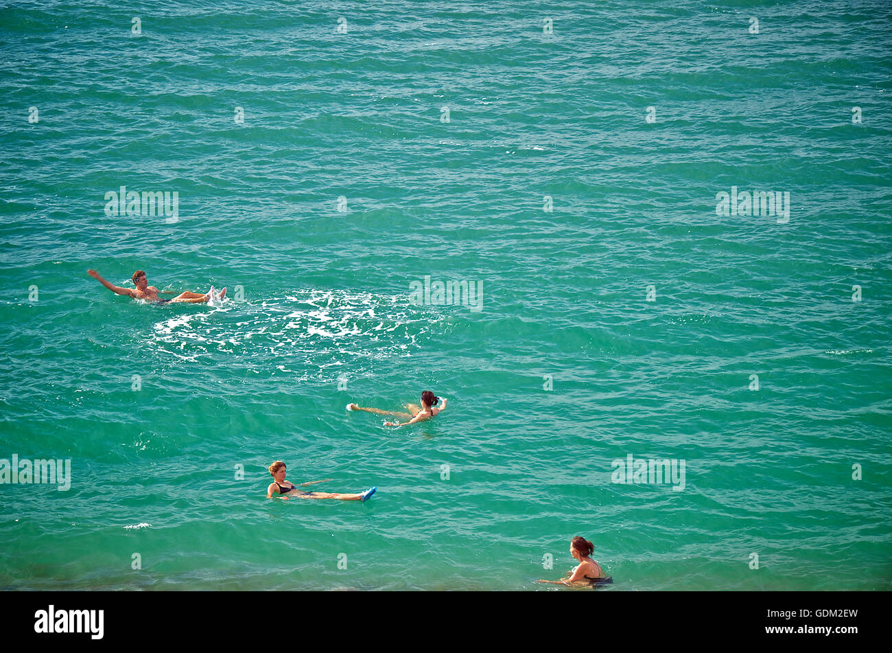 Swimmers floating in the Dead Sea, Jordan Stock Photo - Alamy