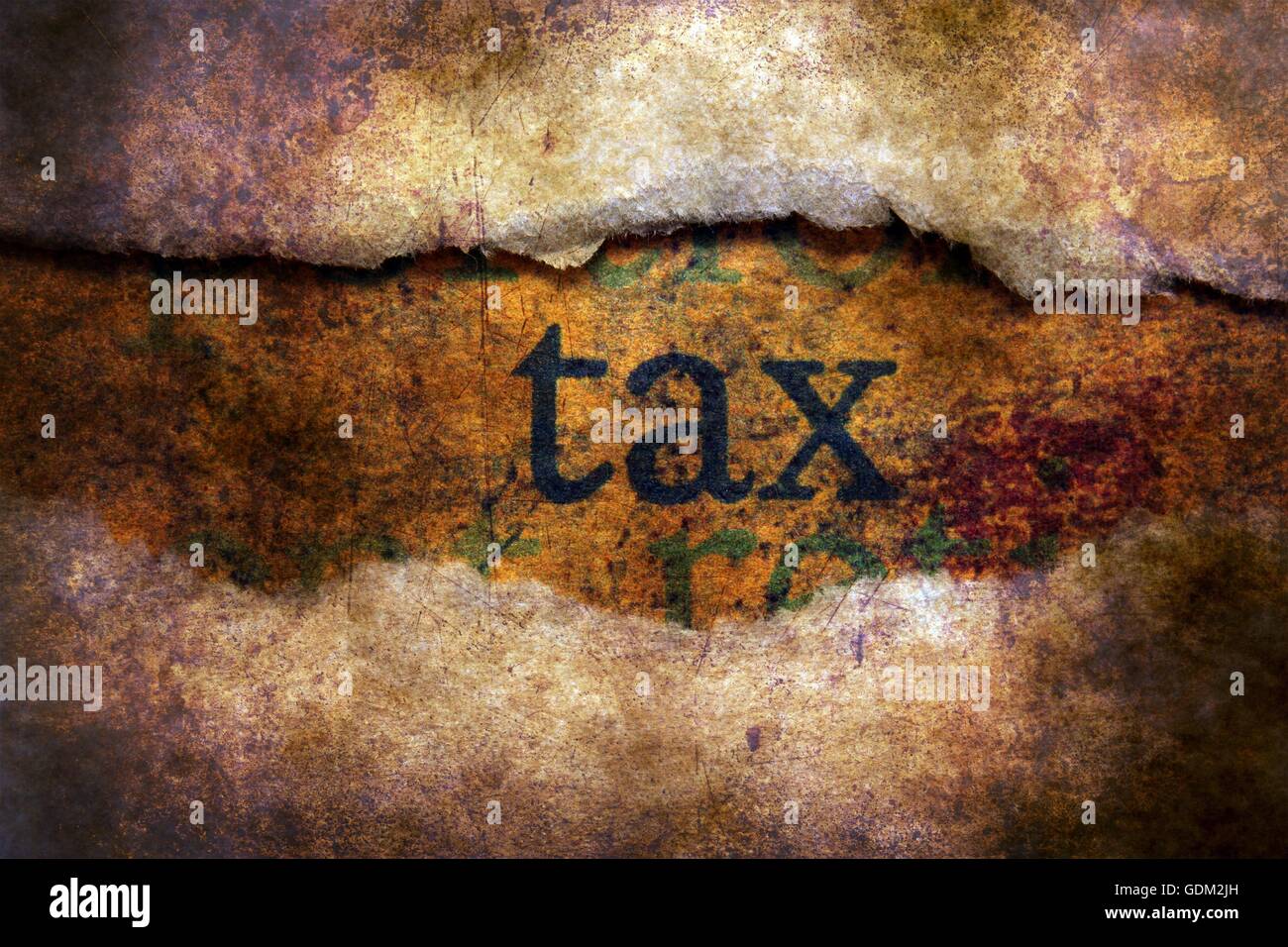 Tax text on paper hole concept Stock Photo - Alamy
