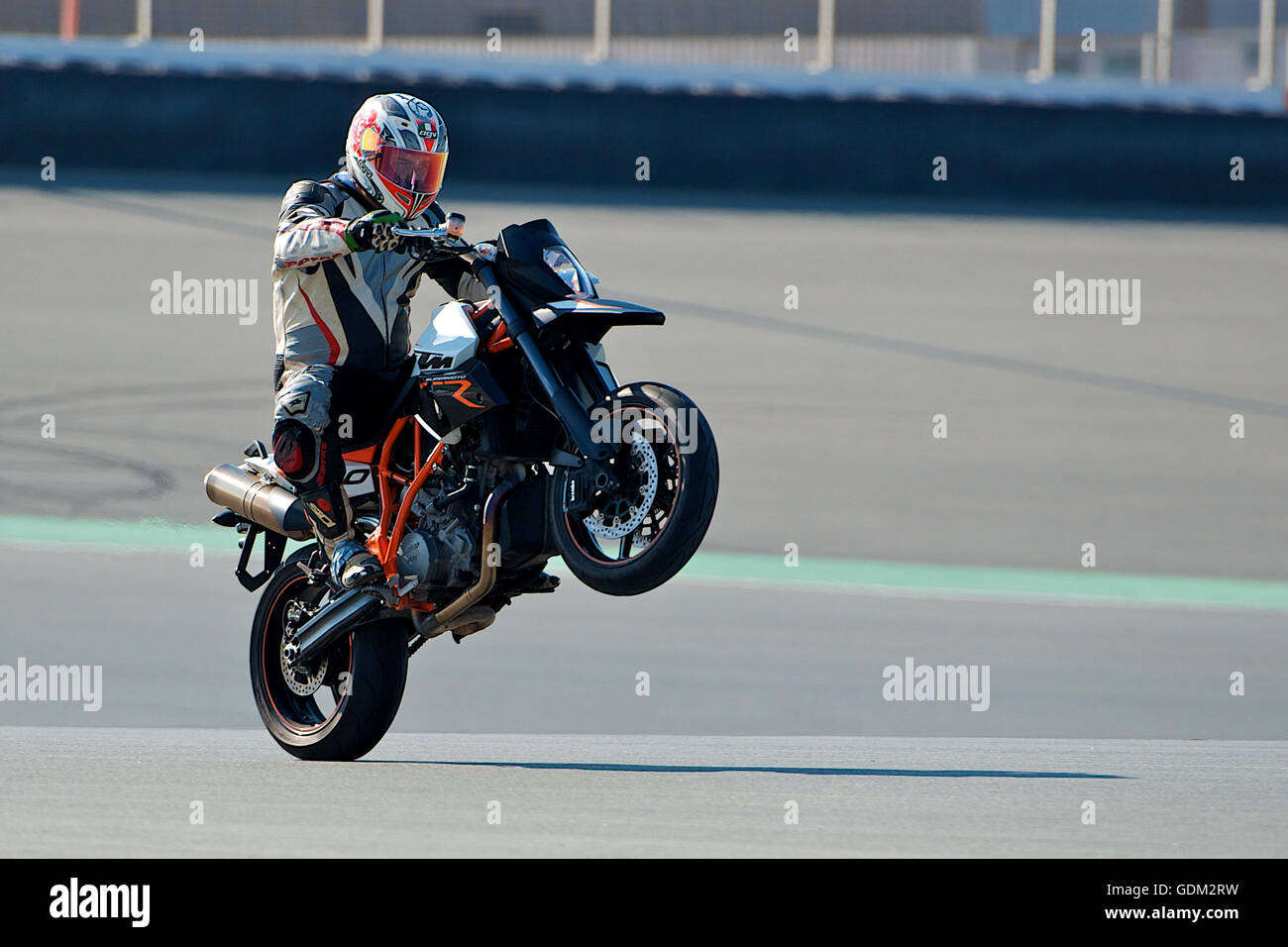 A motorcycle rider pulls a wheelie Stock Photo - Alamy