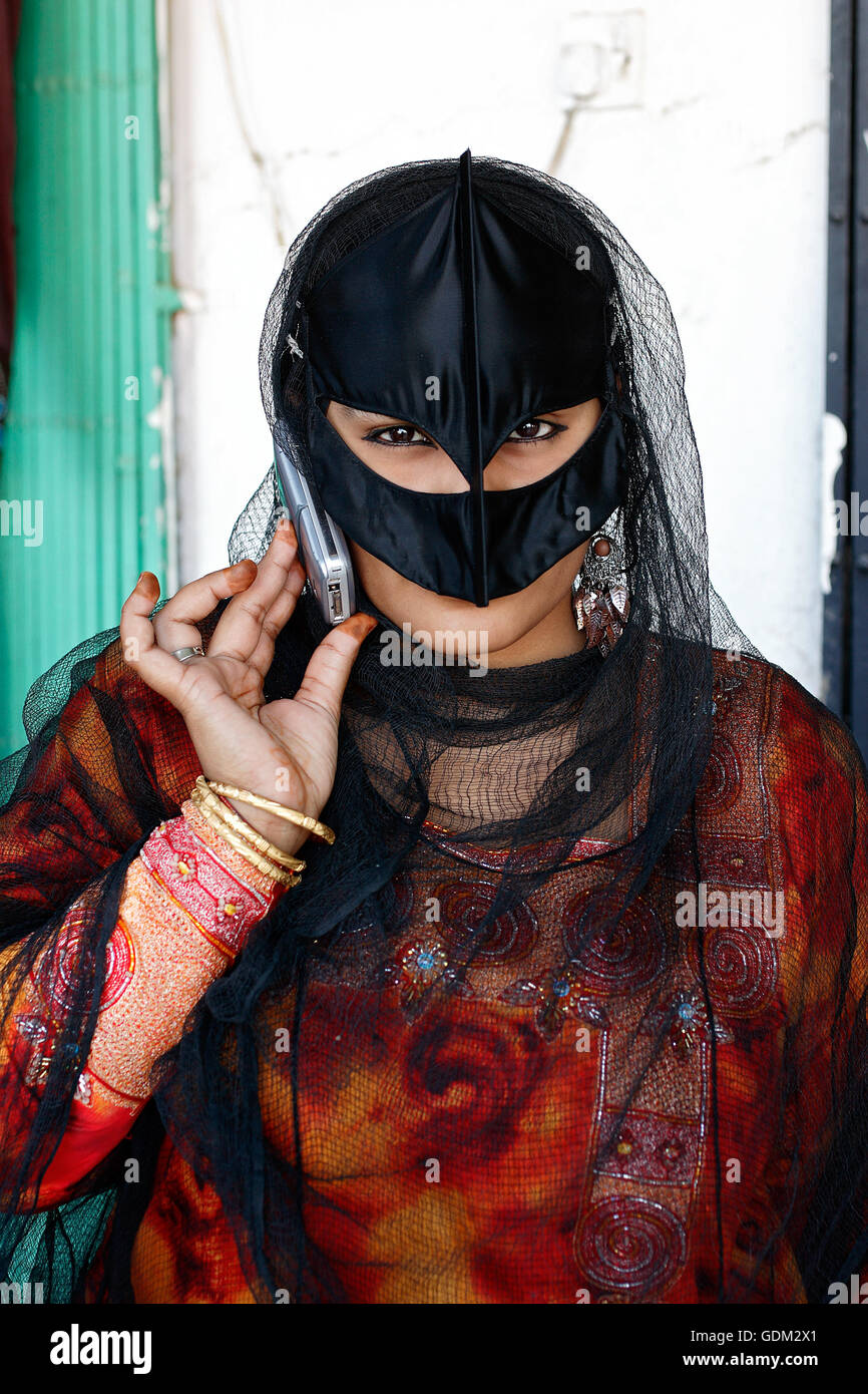 Bedouin lady wearing Burqa using a mobile phone. Oman Stock Photo - Alamy
