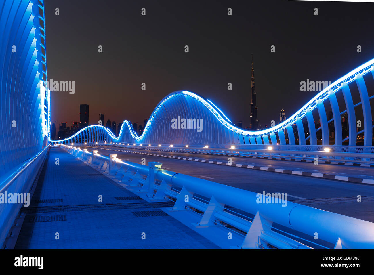 The bridge to Meydan race course with the towers of Sheikh Zayed Road ...
