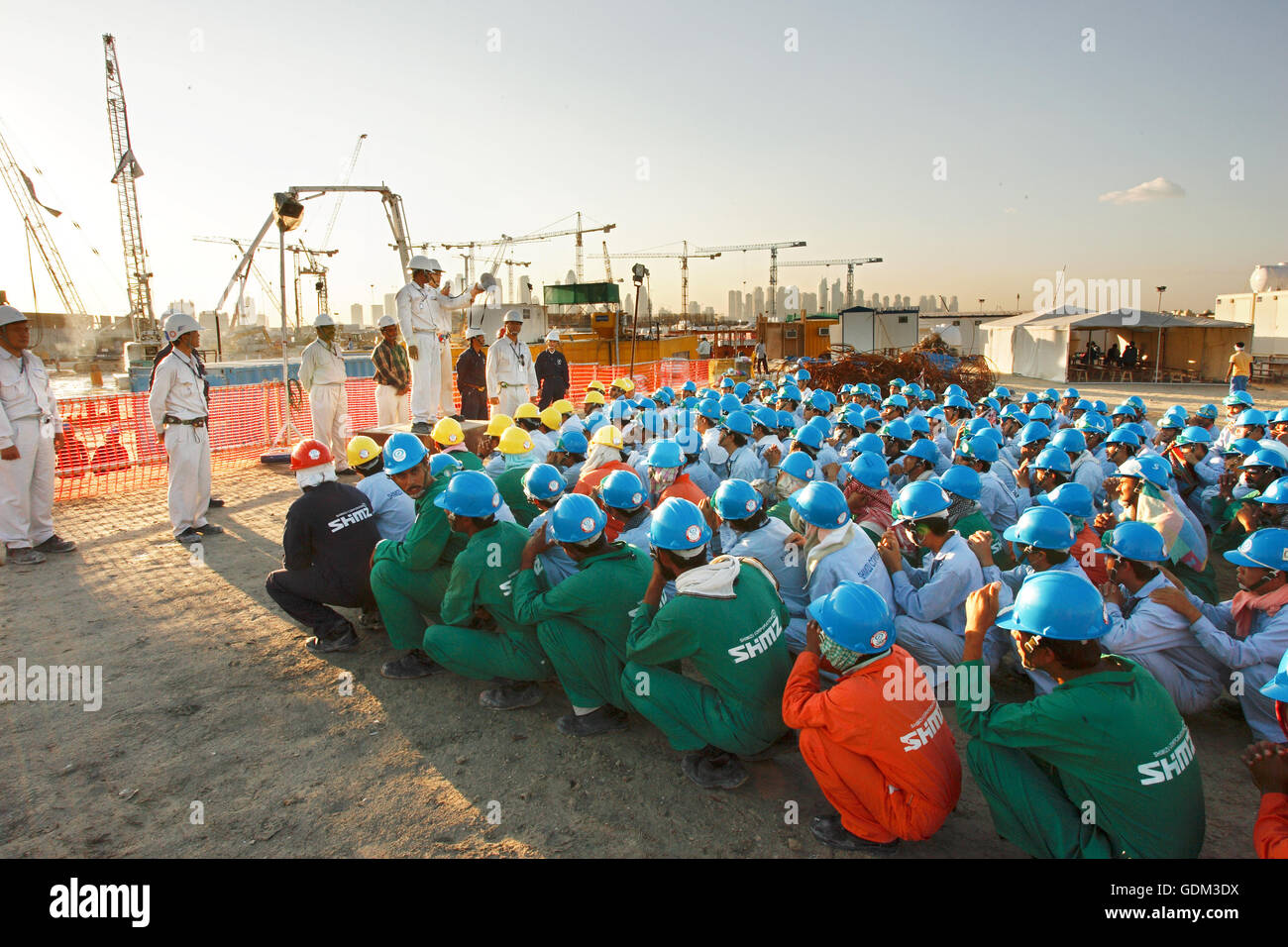 Workers on construction site on Palm Jumeirah (2005) with the JBR ...