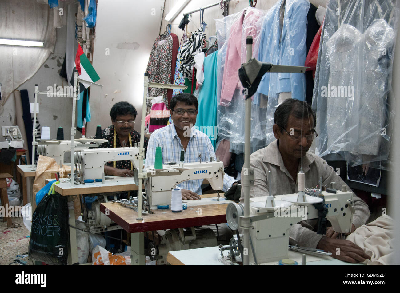 Asian workers in tailor shop in the UAE Stock Photo - Alamy