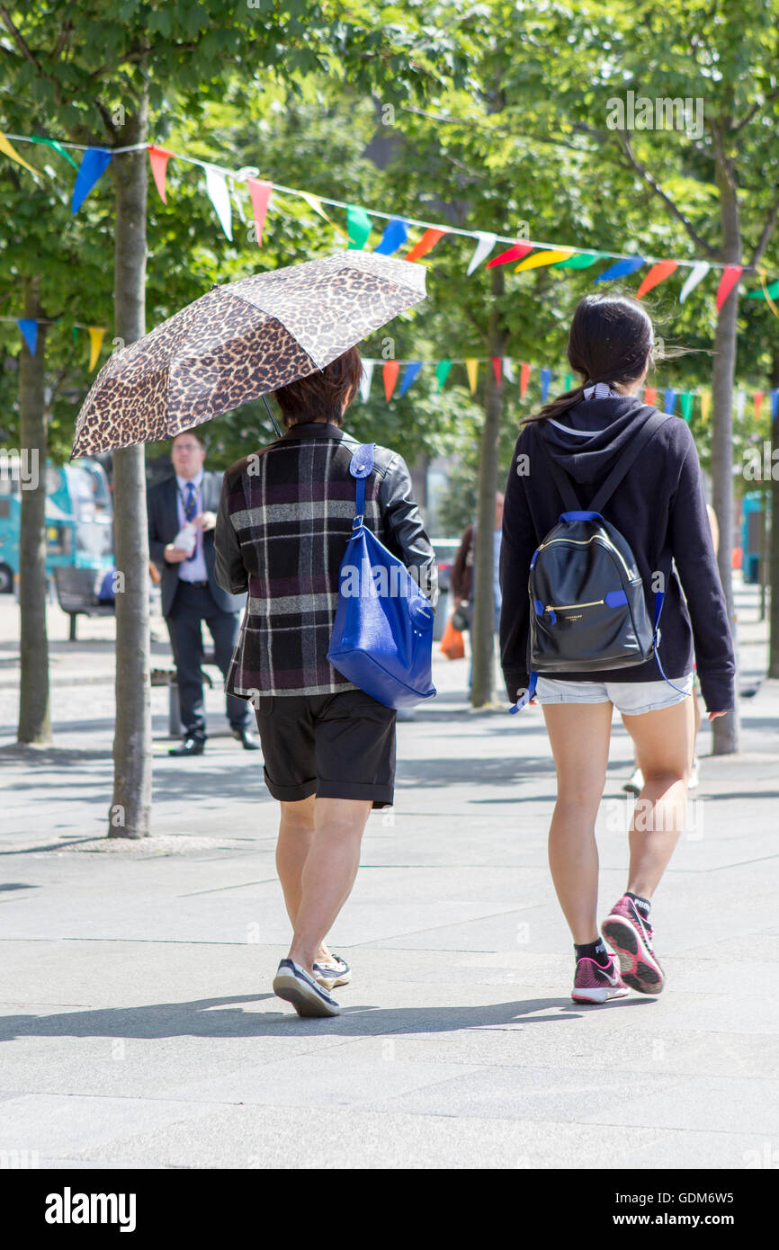 Walking with sun protection umbrellas hi-res stock photography and ...