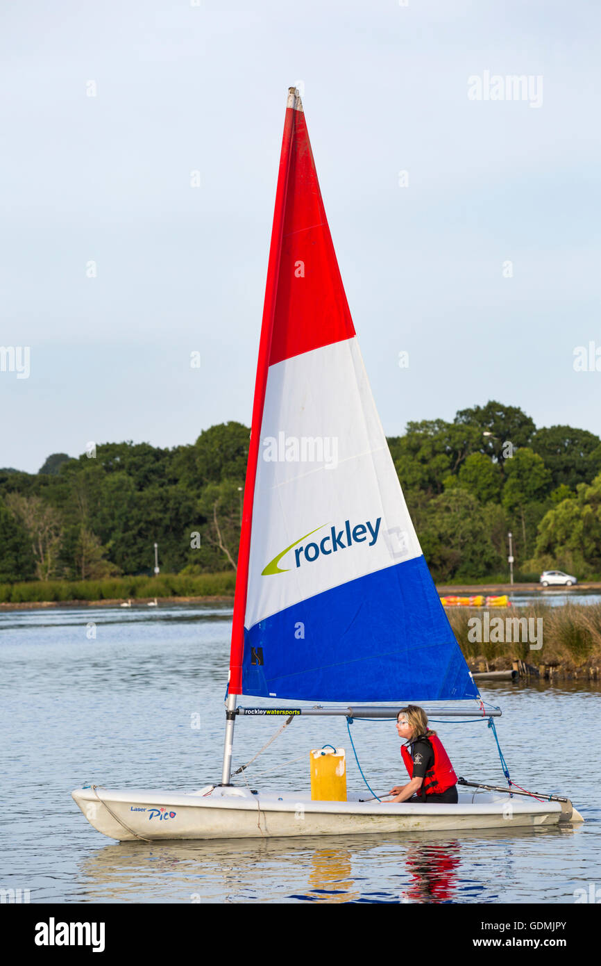 Woman sailing Laser pico dinghy yacht at Poole Park lake, Dorset in ...