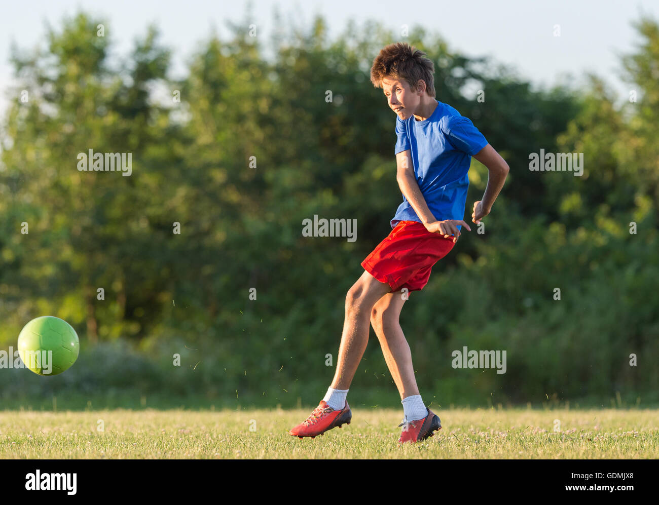 Young boy playing football Stock Photo - Alamy