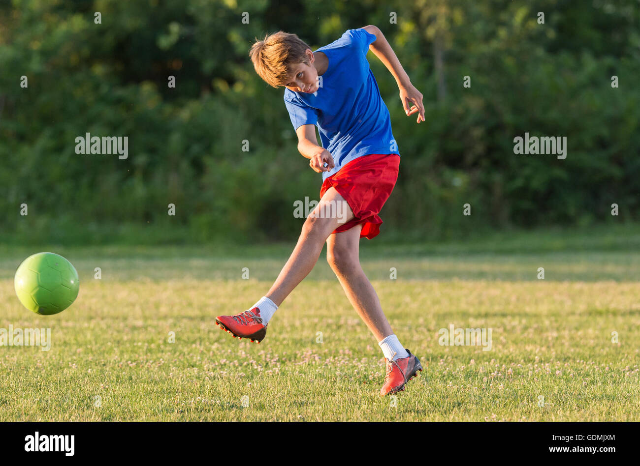 Young boy playing football Stock Photo - Alamy
