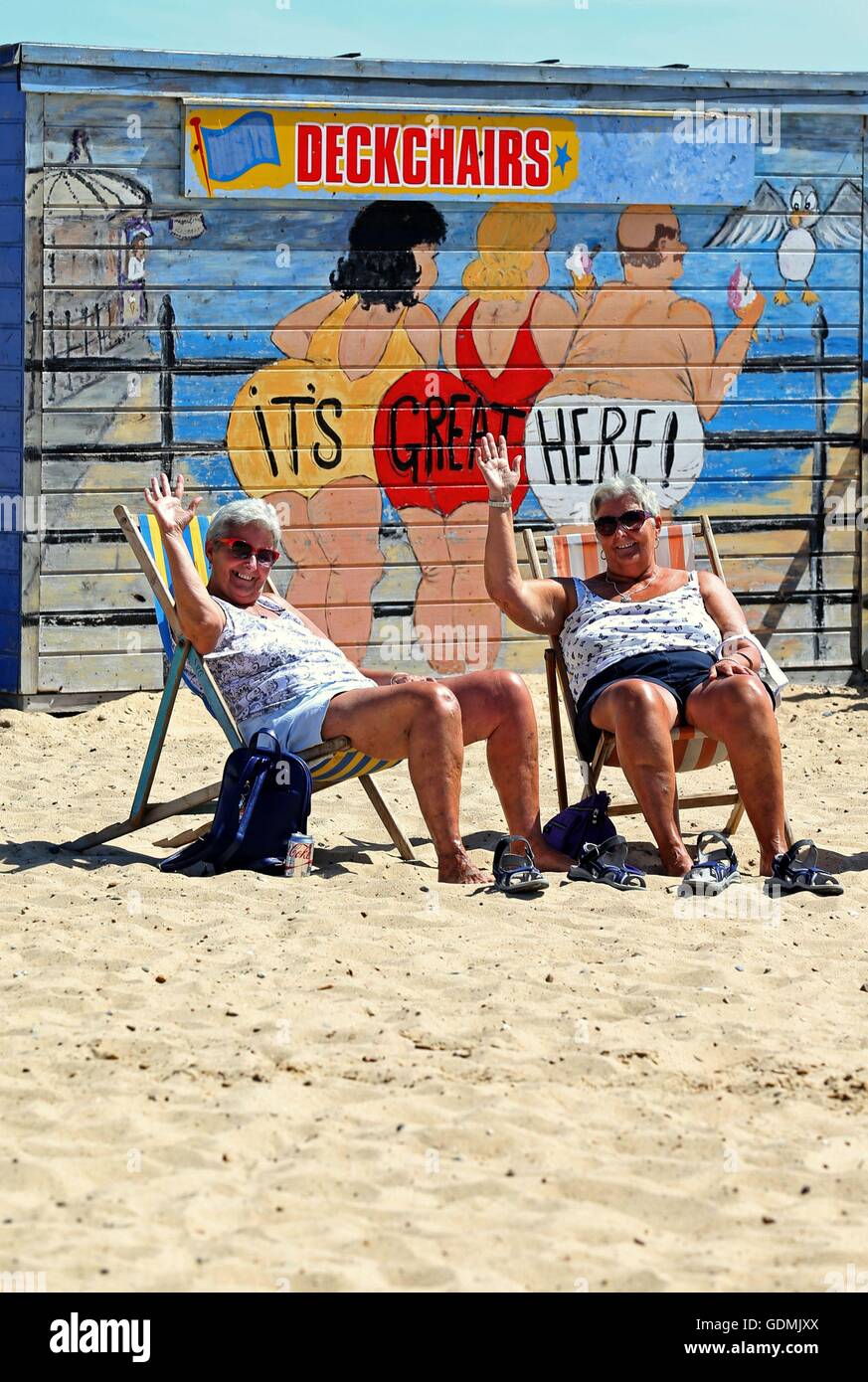 Anne Maw and and twin sister Christine Aspland relax in deckchairs on ...