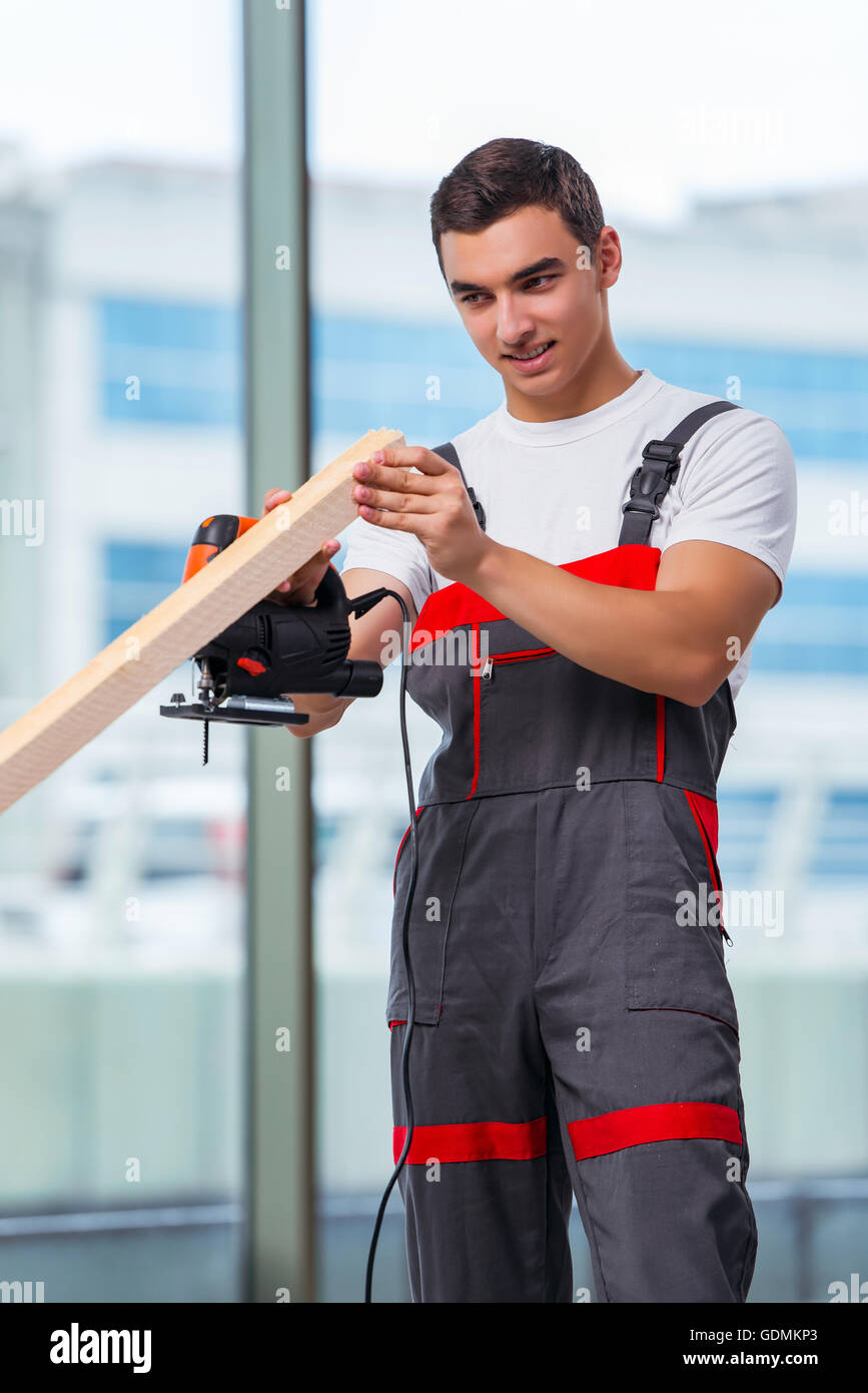 Young carpenter working at construction site Stock Photo - Alamy